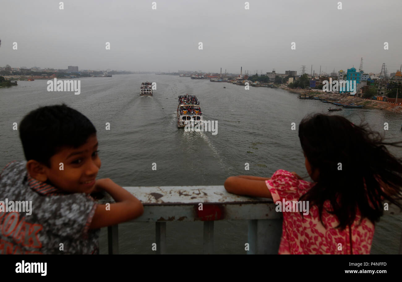 People travel on an overcrowded ferry along the Buriganga River in ...