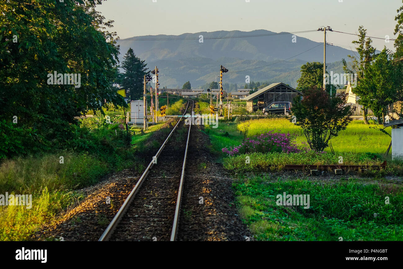A rail track with rural scenery at summer day in Hokkaido, Japan Stock ...