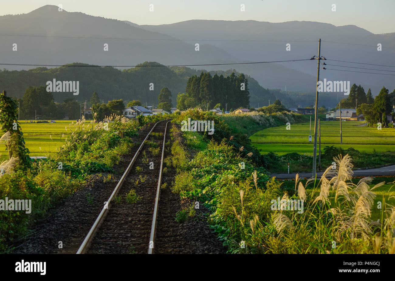 A rail track with rural scenery at summer day in Hokkaido, Japan Stock ...
