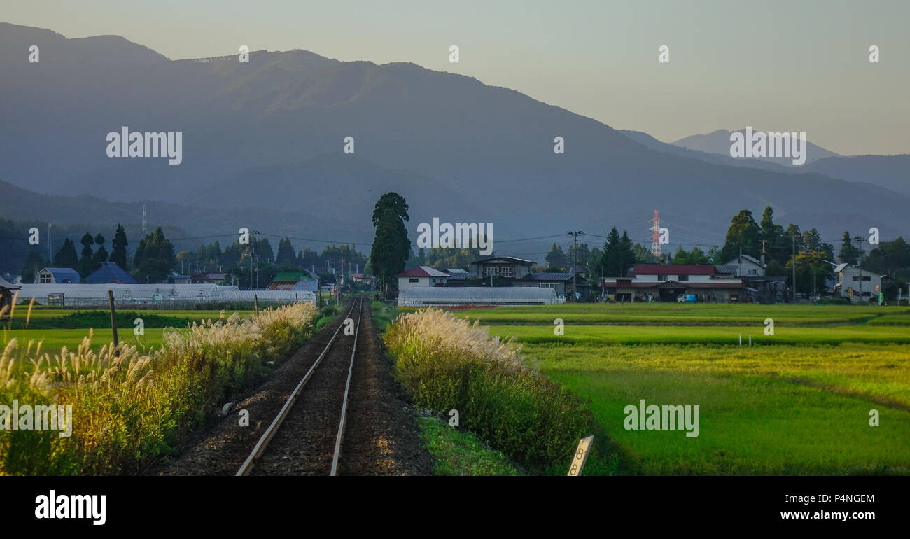 Rail track with rural scenery at sunset in Hokkaido, Japan Stock Photo ...