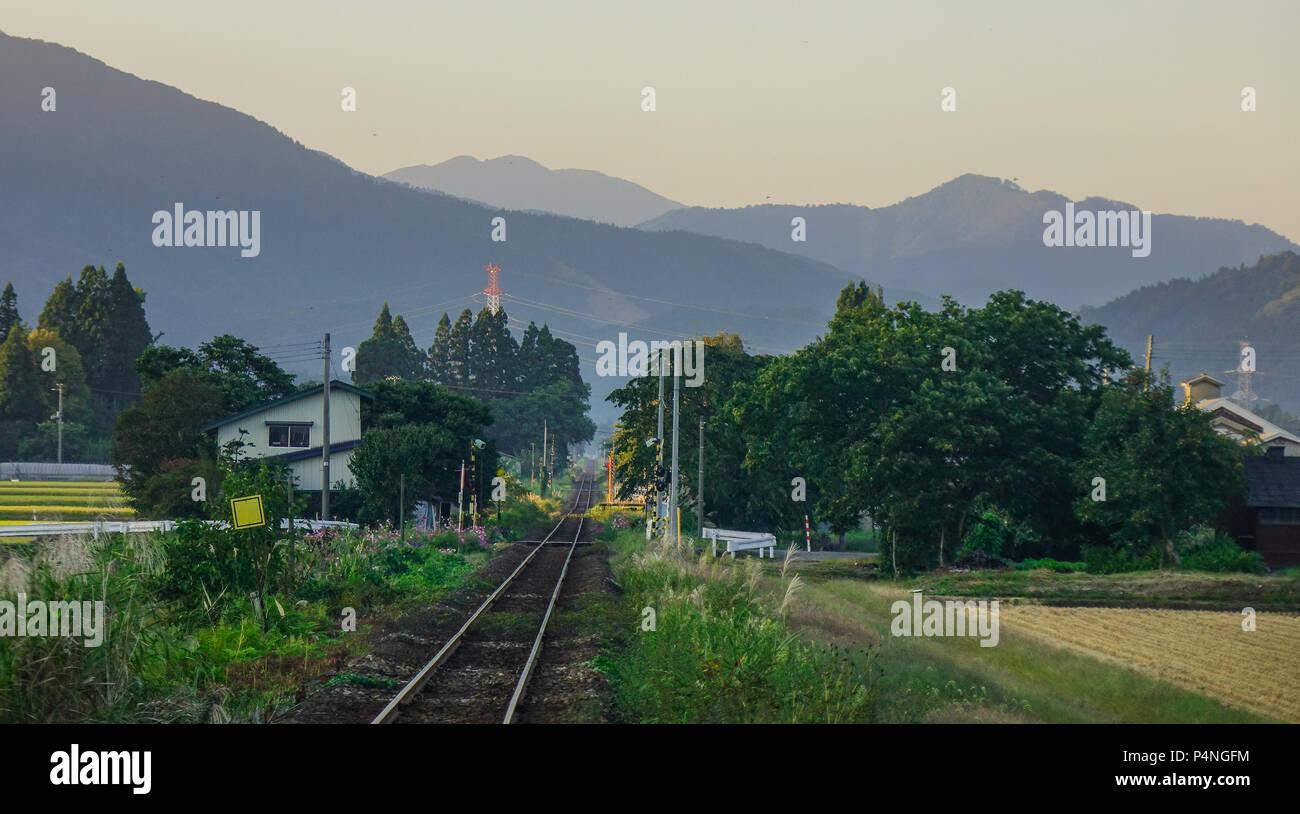 Rail track with rural scenery at sunset in Hokkaido, Japan Stock Photo ...