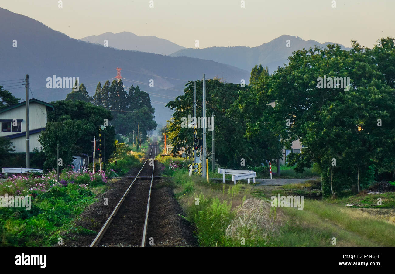 Rail track with rural scenery at sunset in Hokkaido, Japan Stock Photo ...