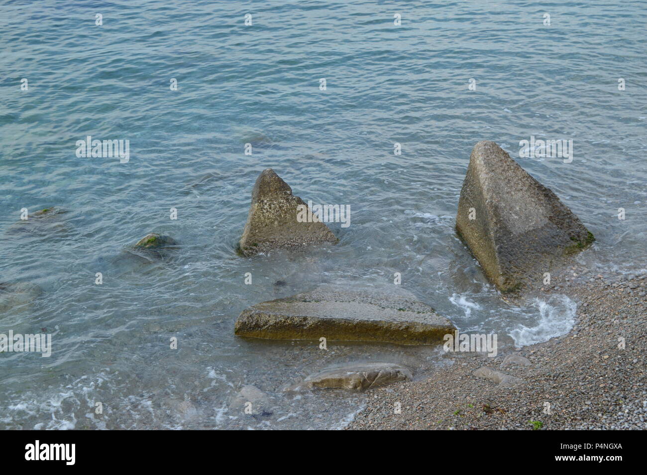 The waves of the sea beating on the huge boulders on the shore Stock ...