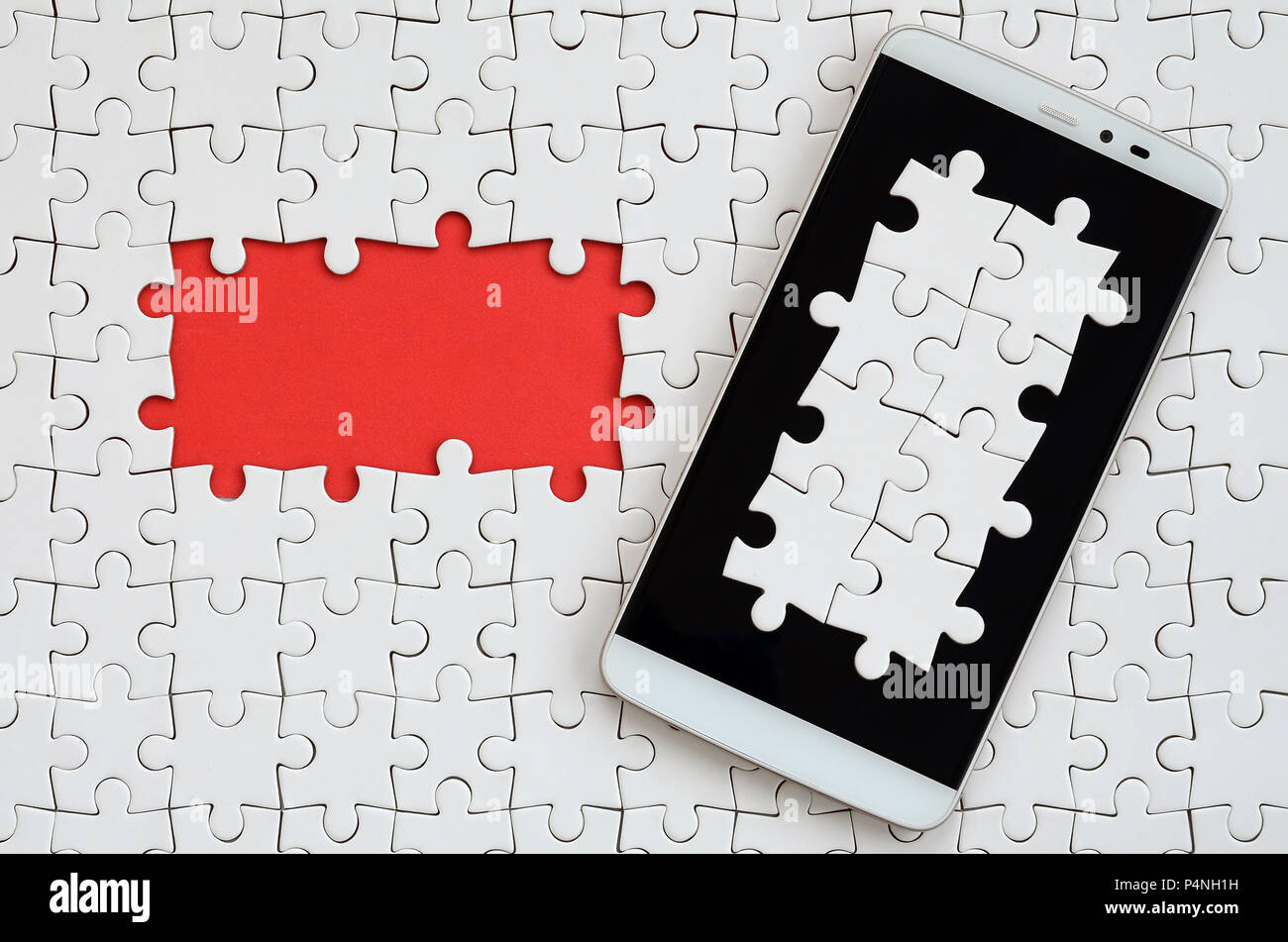 A modern big smartphone with several puzzle elements on the touch ...