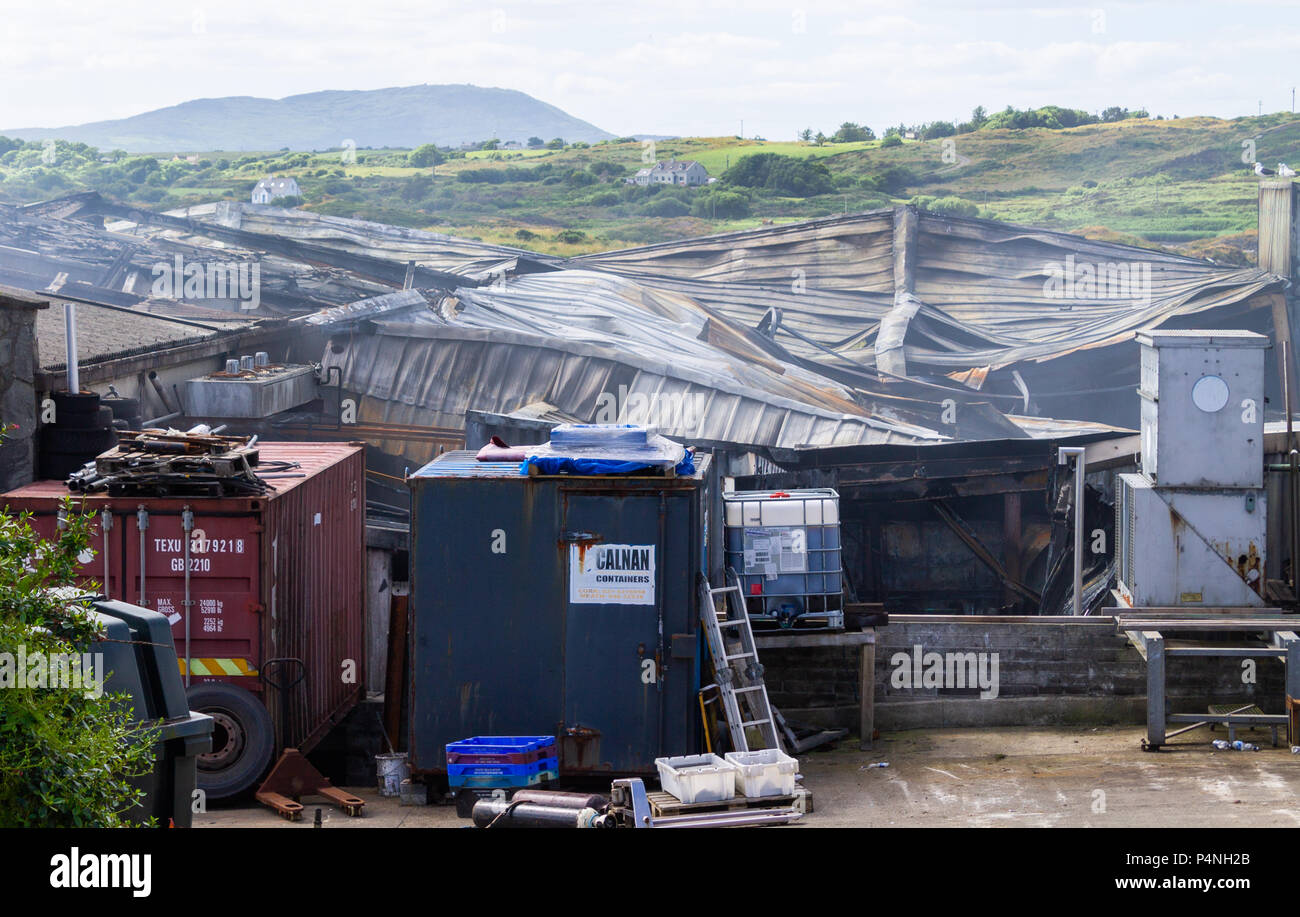 burnt out factory building, the metal roof and walls twisted by the ...