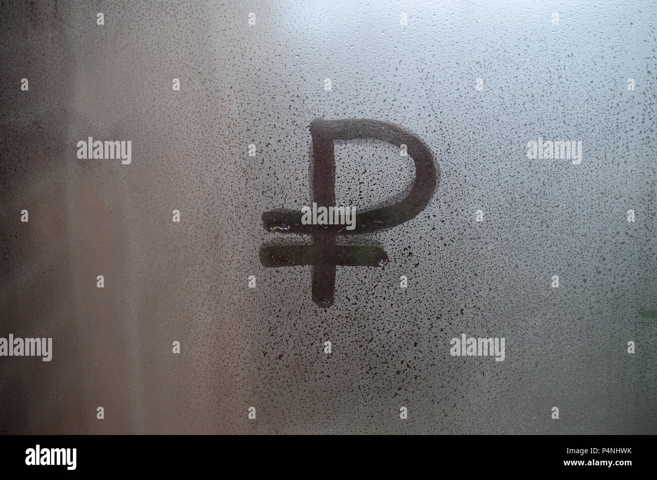 Symbol of the Russian ruble is written with a finger on the surface of ...