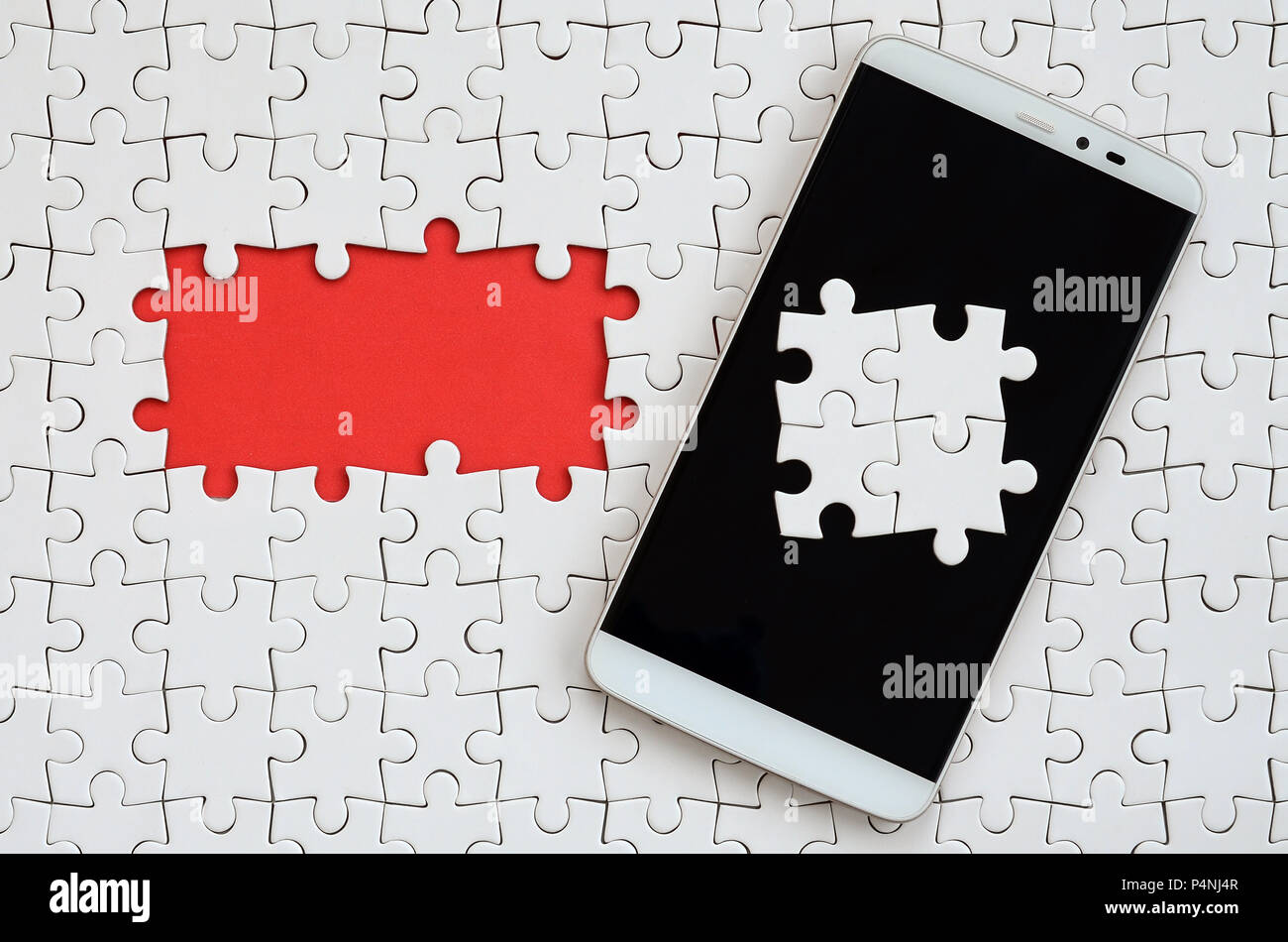 A modern big smartphone with several puzzle elements on the touch ...