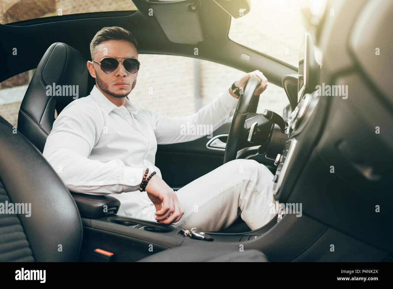 Handsome Young Man Sitting in the Luxury Vehicle Stock Photo - Alamy