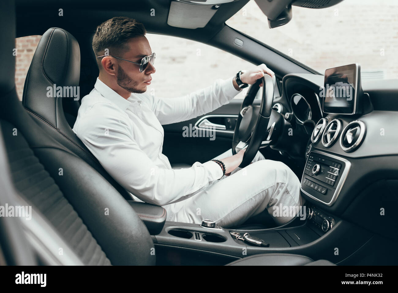 Handsome Young Man Sitting in the Luxury Vehicle Stock Photo - Alamy