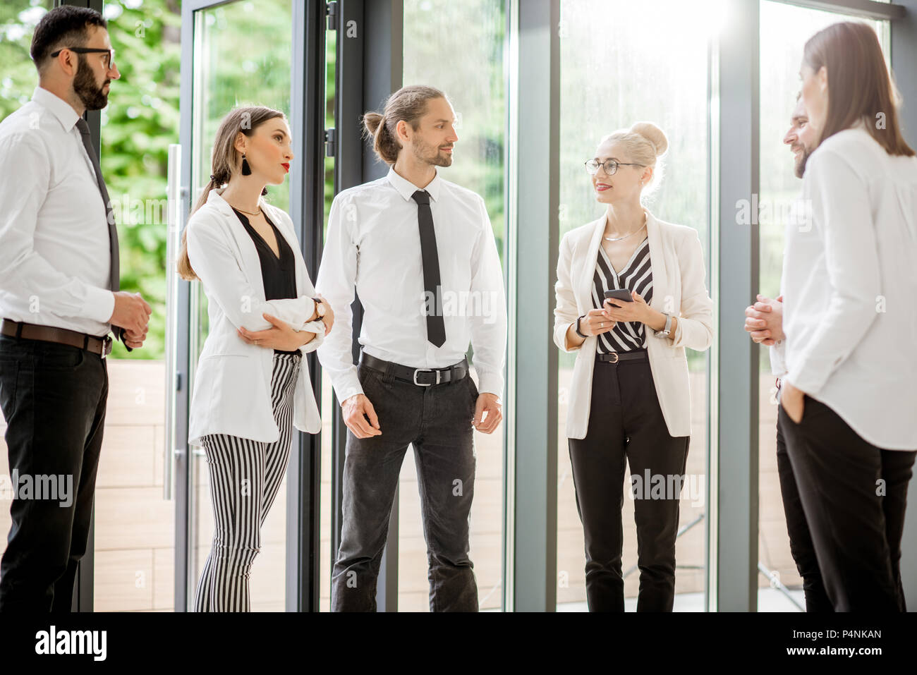 Business people talking together indoors Stock Photo - Alamy