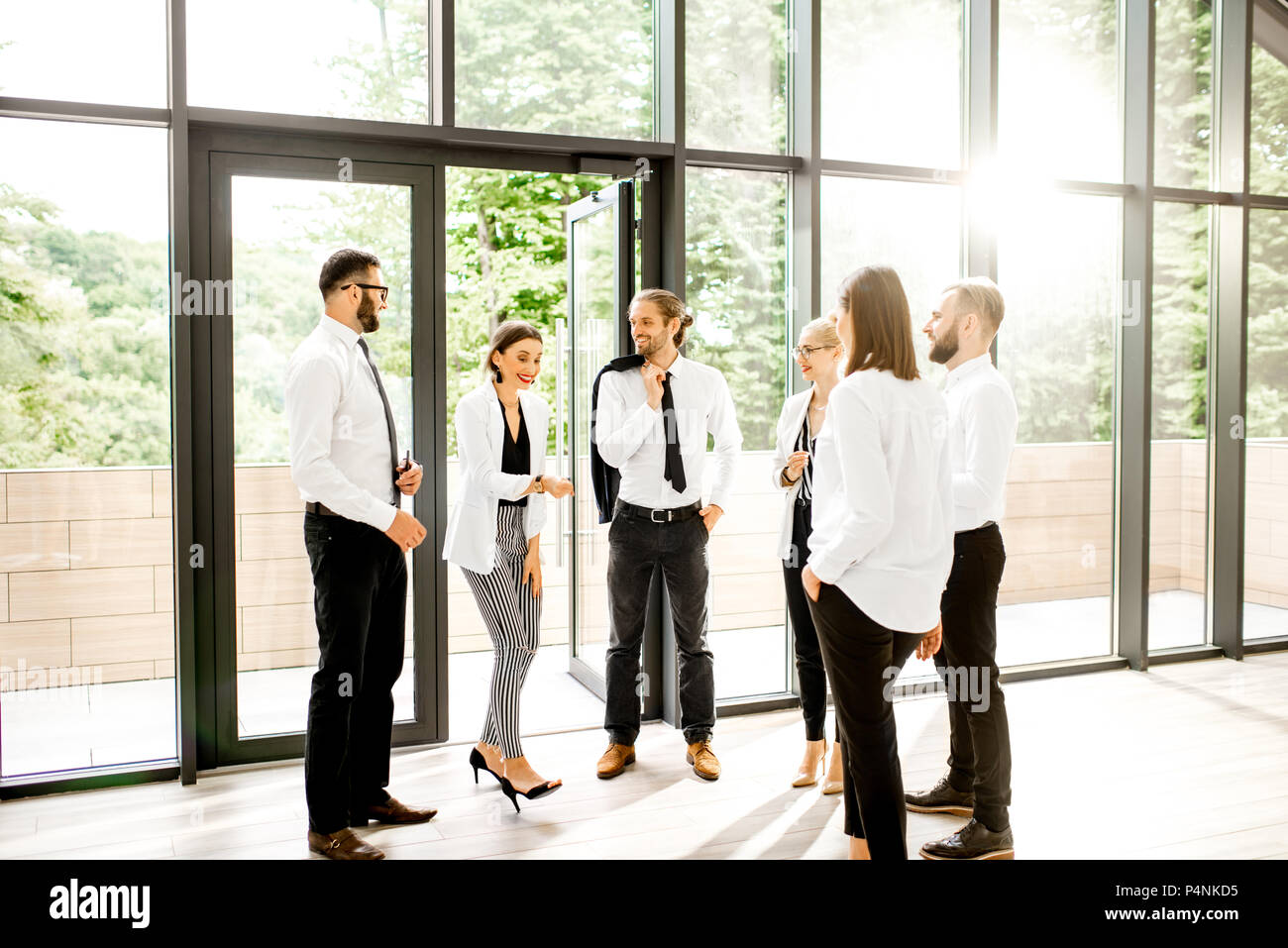 Business people talking together indoors Stock Photo - Alamy