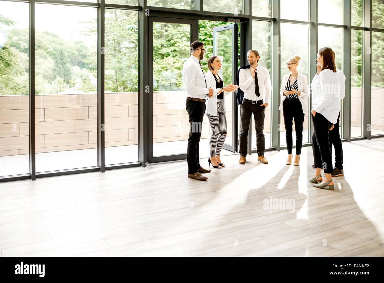 Business people talking at the office hall Stock Photo - Alamy