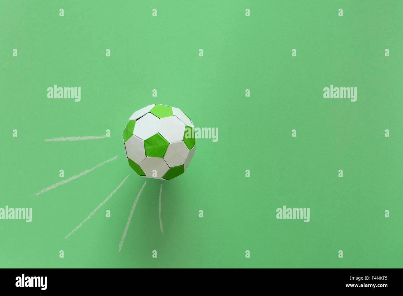 Paper soccer ball on soccer field or green background. Origami. Paper ...