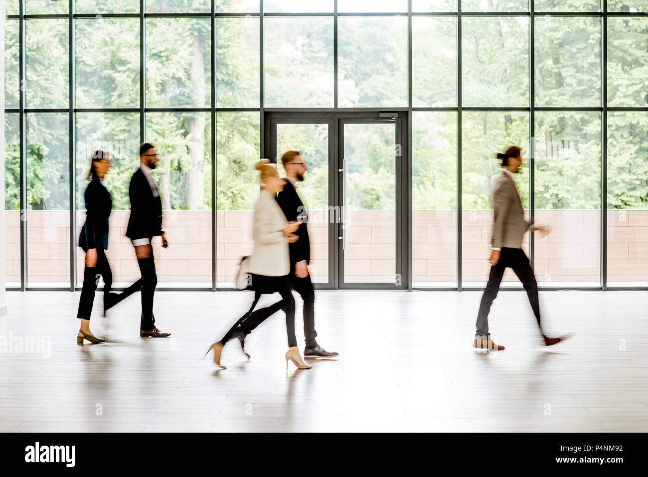 Business people walking indoors Stock Photo - Alamy