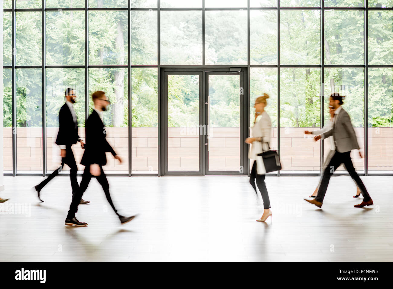 Business people walking indoors Stock Photo - Alamy