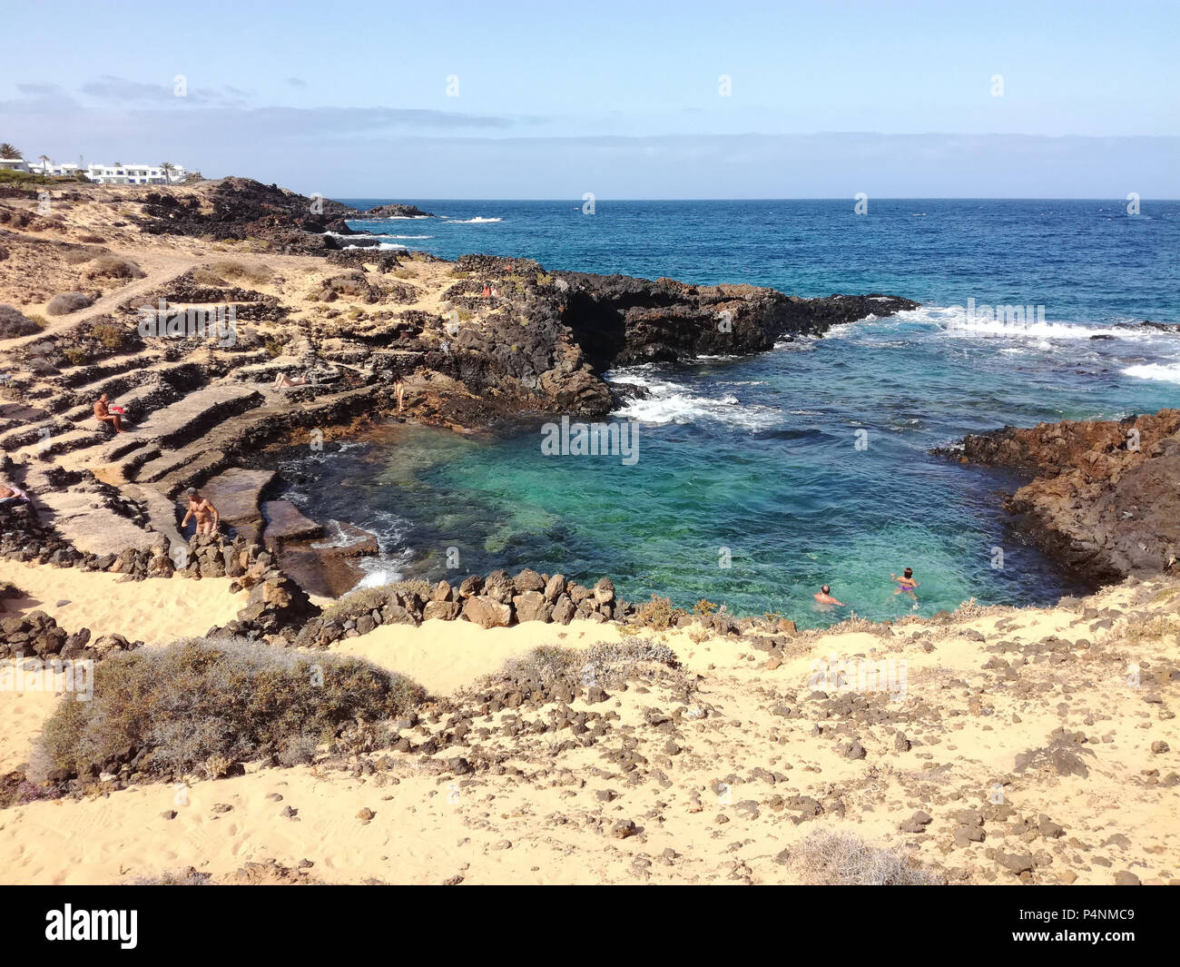 Swimmers and nudists enjoy the sun in the Tidal Pool in Charco del Palo ...