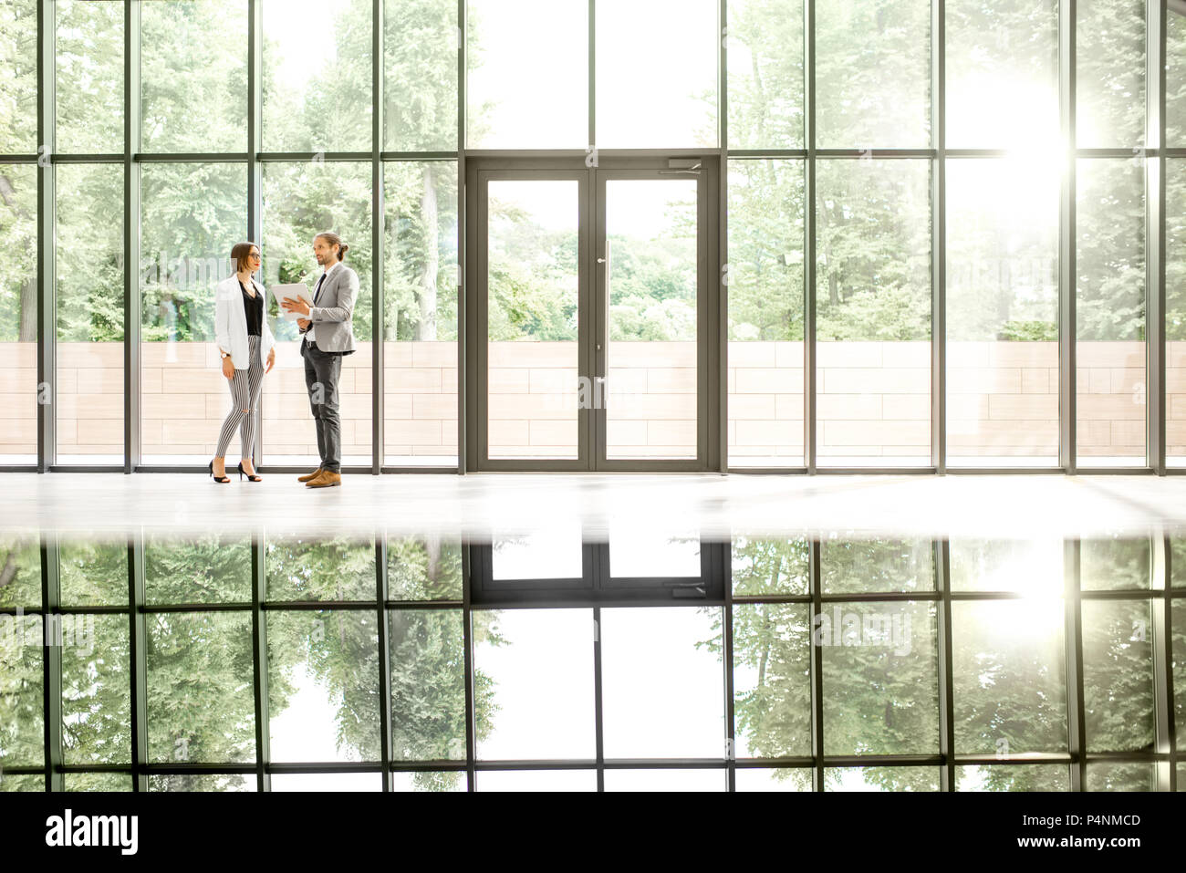 Business couple at the beautiful office hall Stock Photo - Alamy