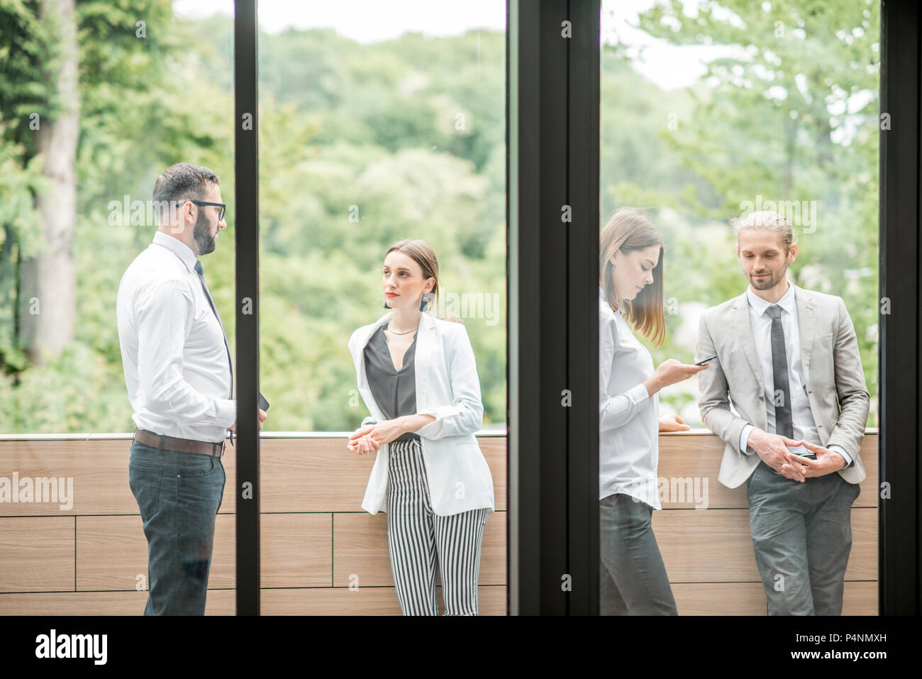 Business people on the office balcony during a break Stock Photo - Alamy