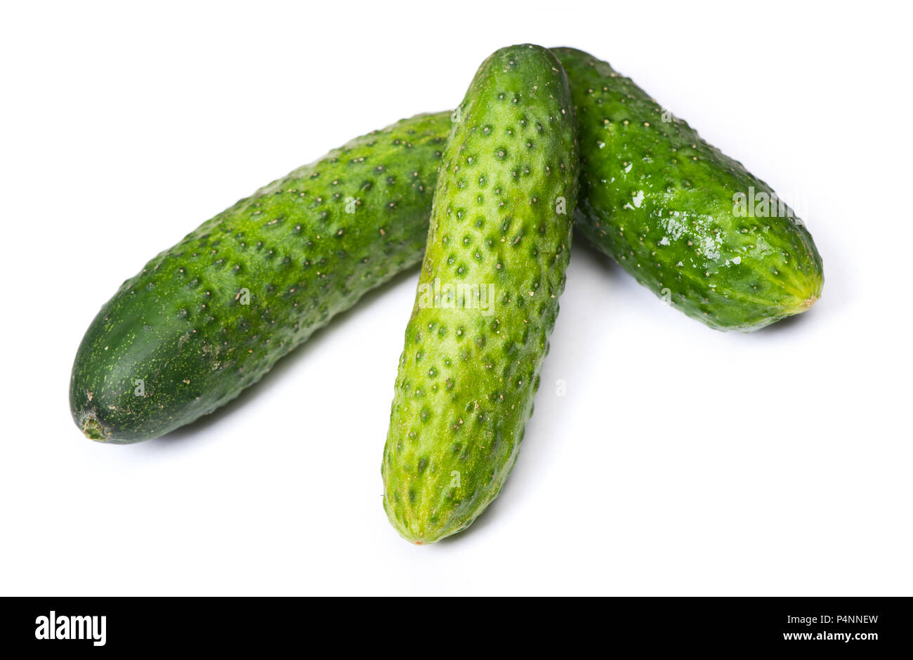 Few natural cucumbers isolated on white background Stock Photo - Alamy