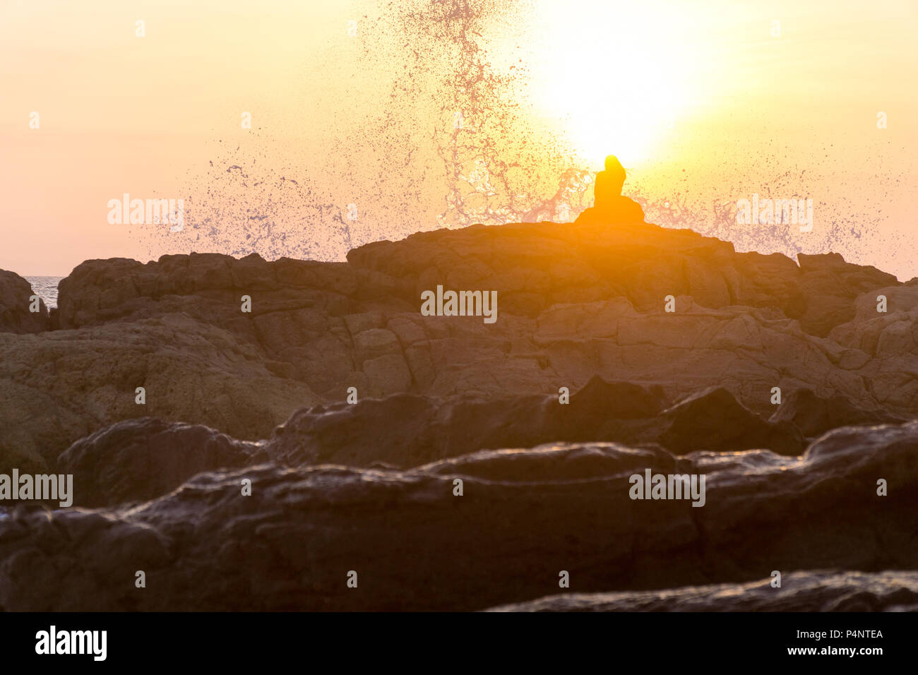 Silhouette woman sitting on rock hi-res stock photography and images ...