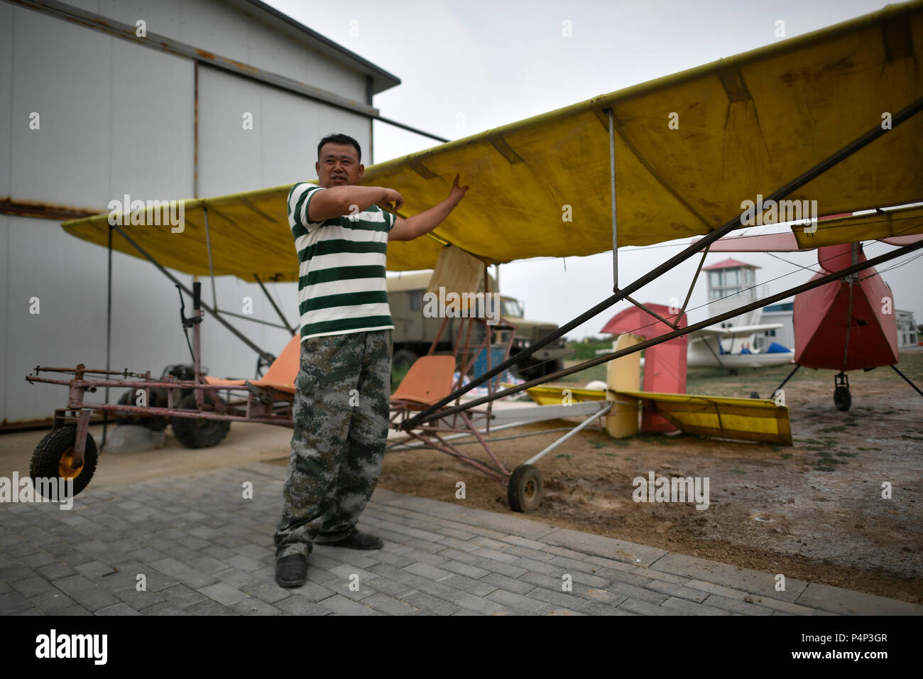 Yinchuan, China. 23rd June 2018. Liu Yibing stands in front of a plane ...
