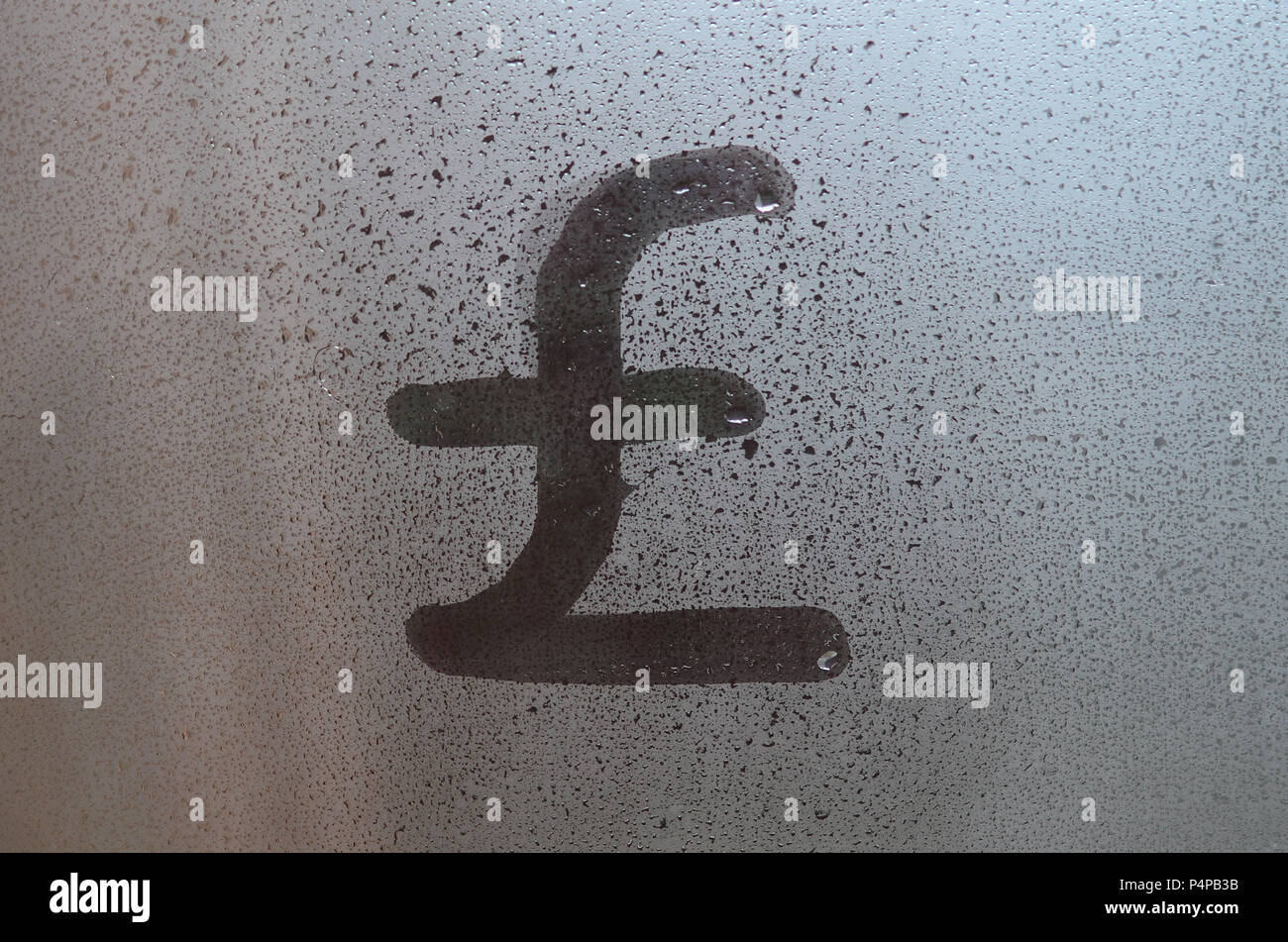 Symbol of English pounds is written with a finger on the surface of the ...