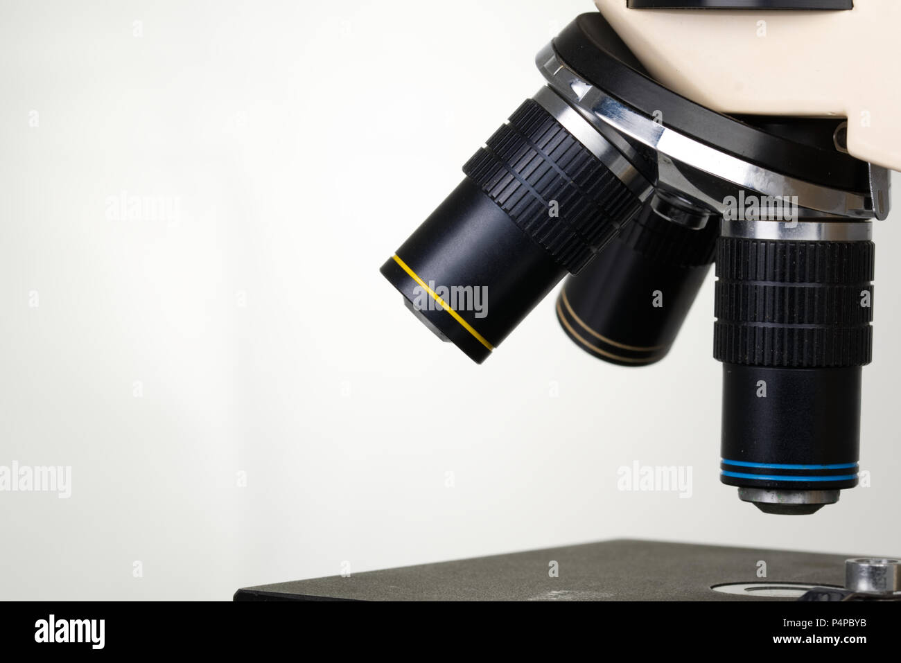 Close up of the lenses of a microscope on white background, Scientific ...