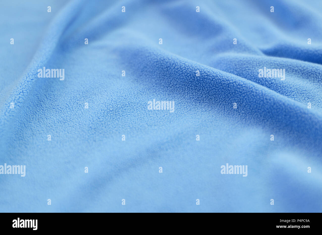 The blanket of furry blue fleece fabric. A background of light blue ...