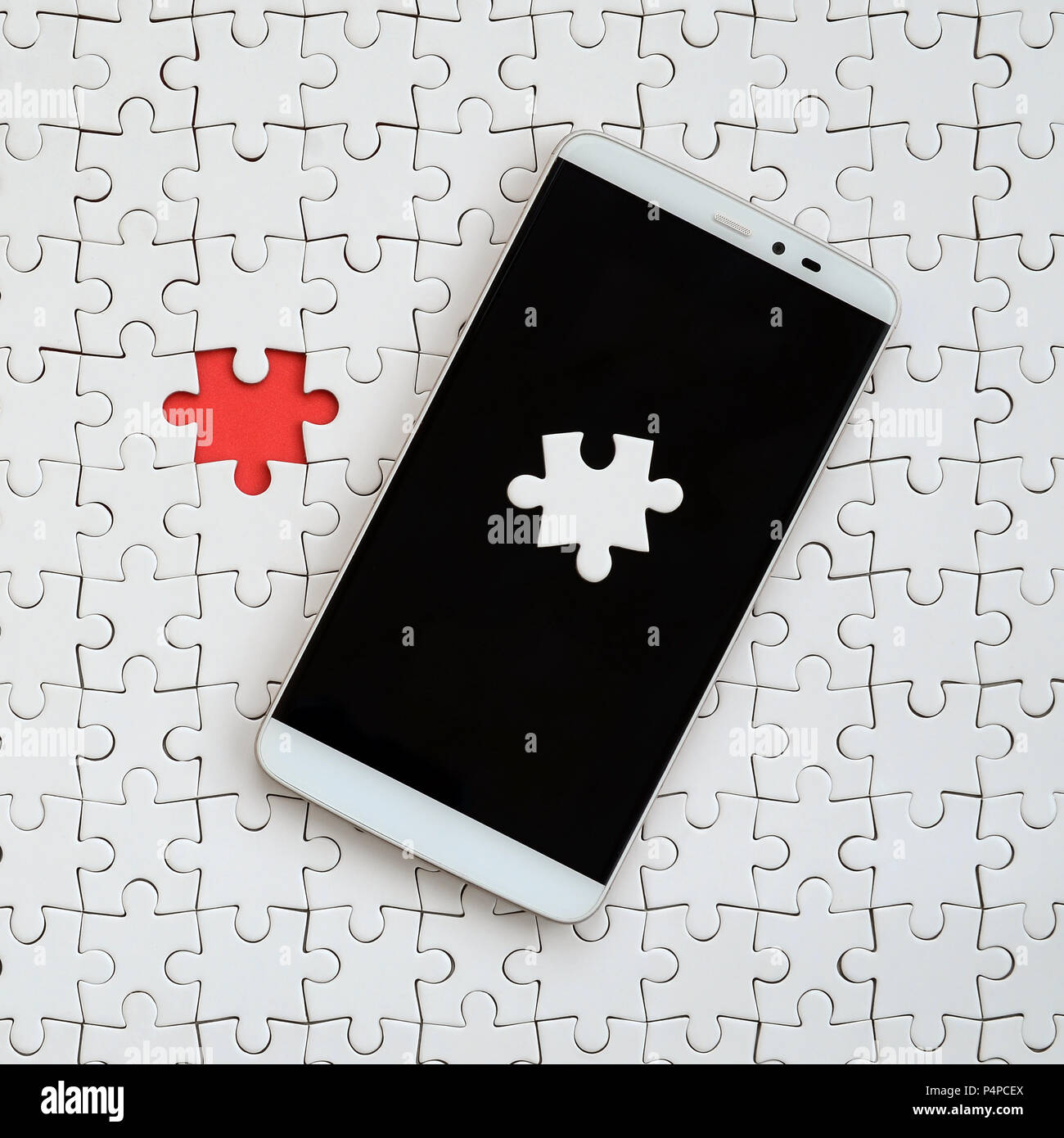 A modern big smartphone with several puzzle elements on the touch ...