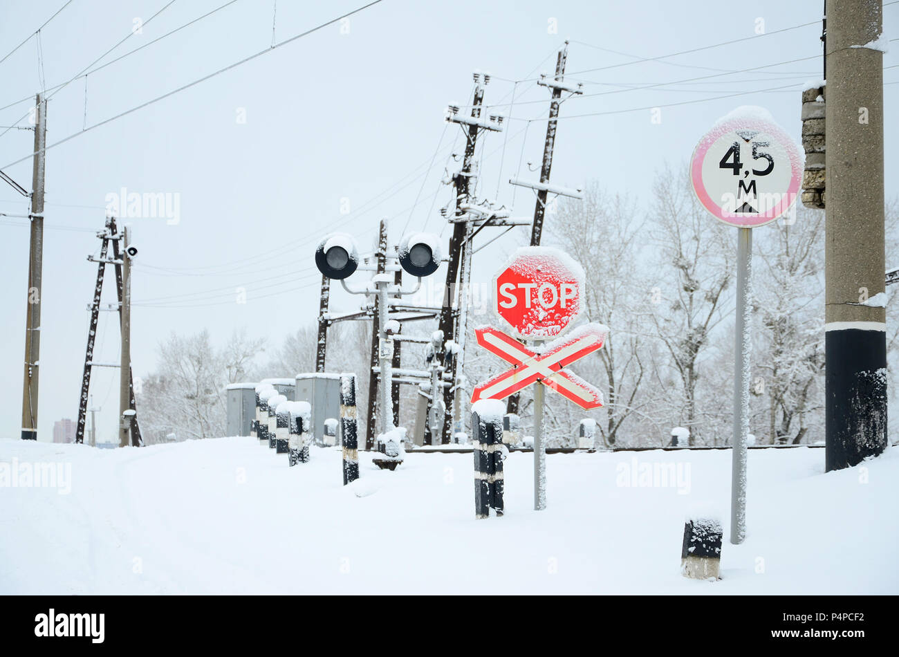 Stop. Red road sign is located on the motorway crossing the railway ...