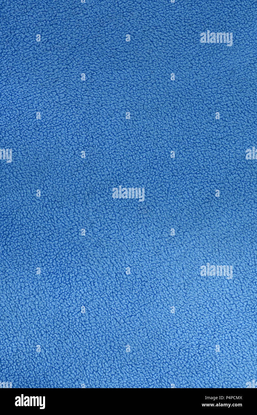 The blanket of furry blue fleece fabric. A background texture of light ...