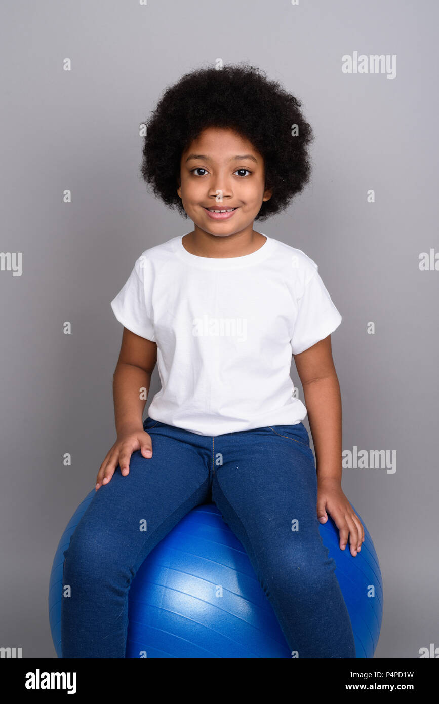 Young cute African girl against gray background Stock Photo - Alamy