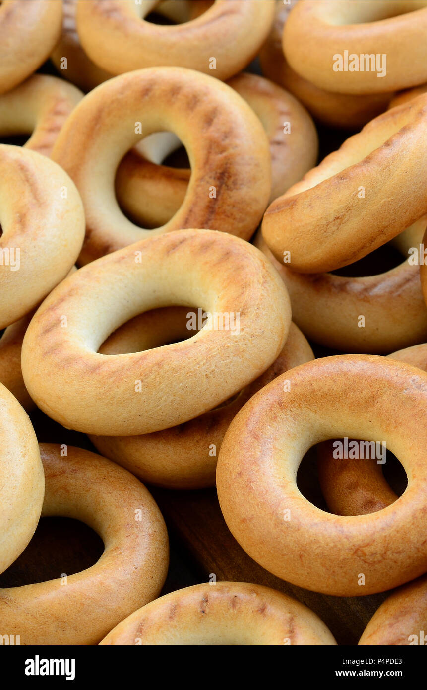 Close-up photo of fresh yellow bagels. A popular kind of flour products ...