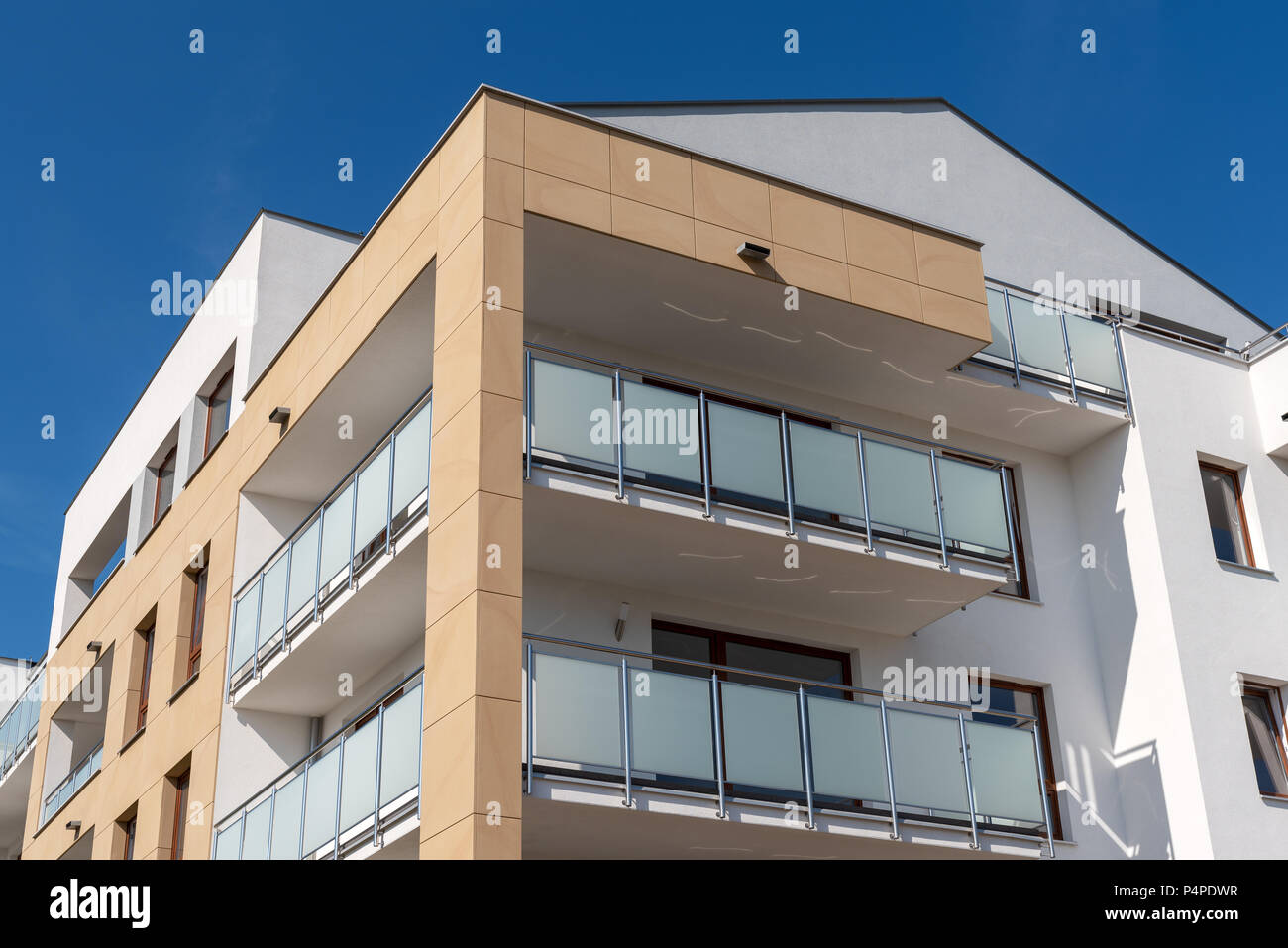 Modern apartment block with balcony against a blue sky Stock Photo - Alamy