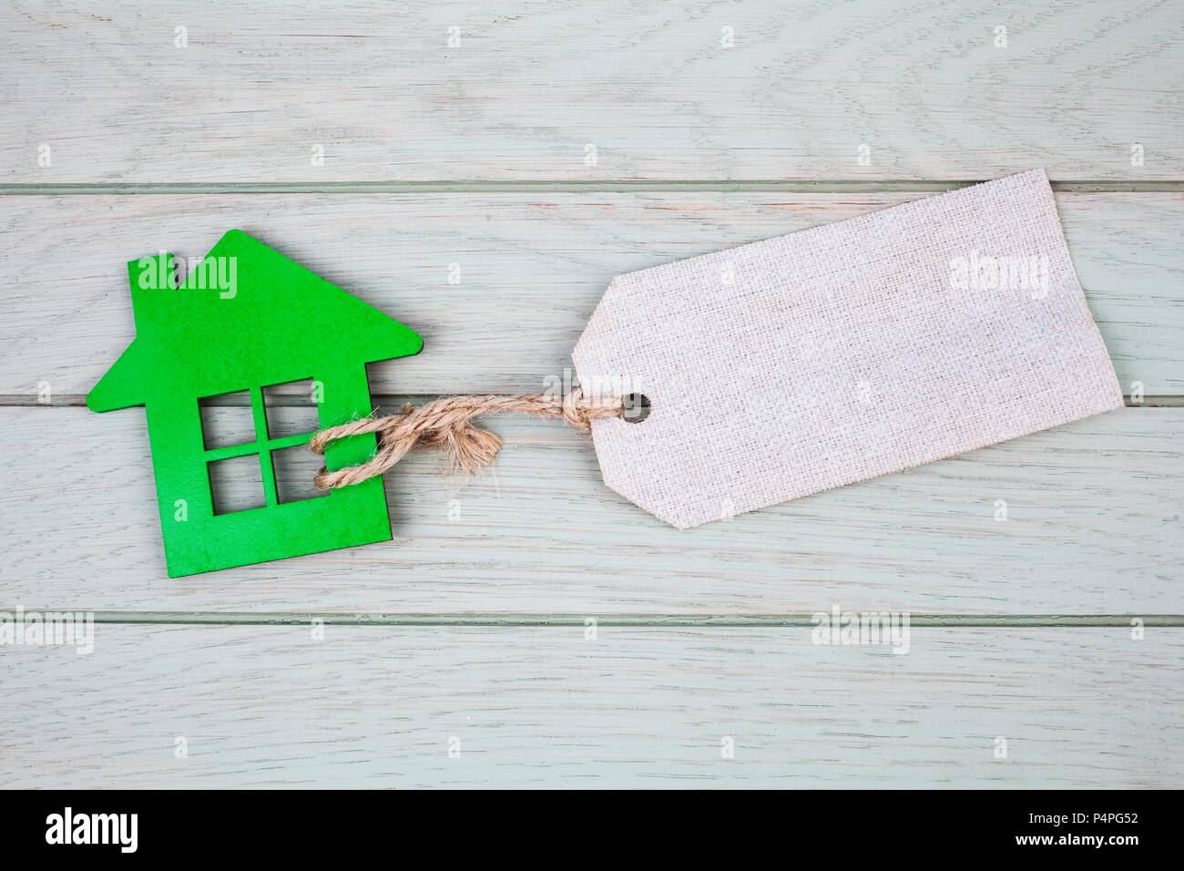 Small house with label over a wooden background Stock Photo - Alamy