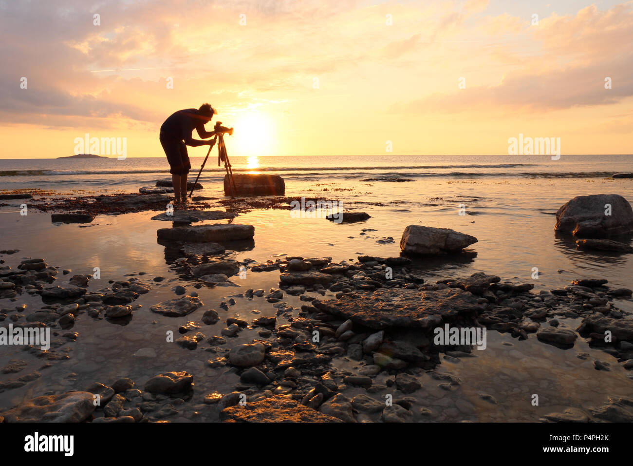 Nature photographer working at sunset to create nature photographs at ...