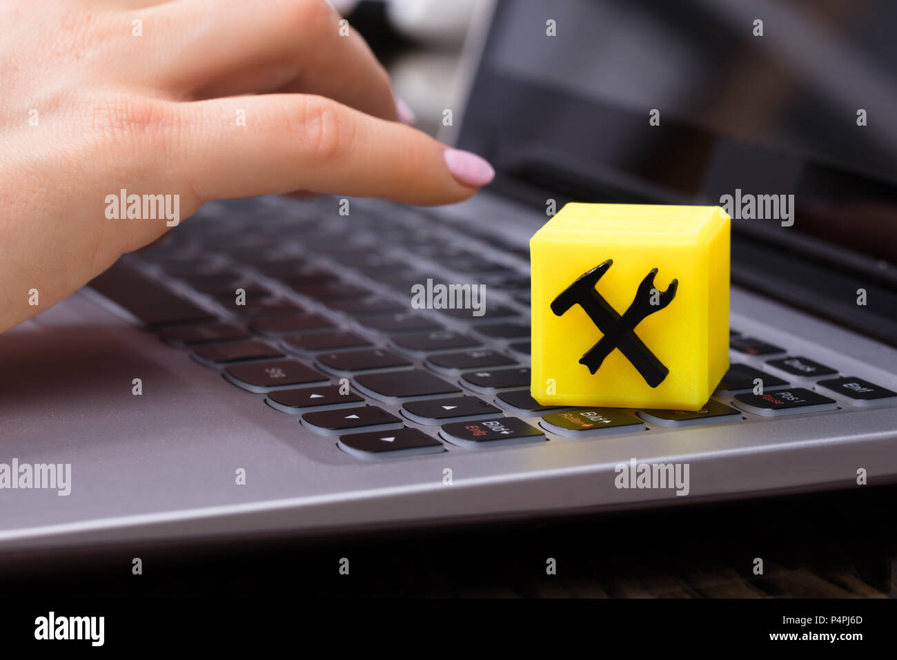 Businesswoman's Hand With Yellow Cubic Block Showing Under Construction ...