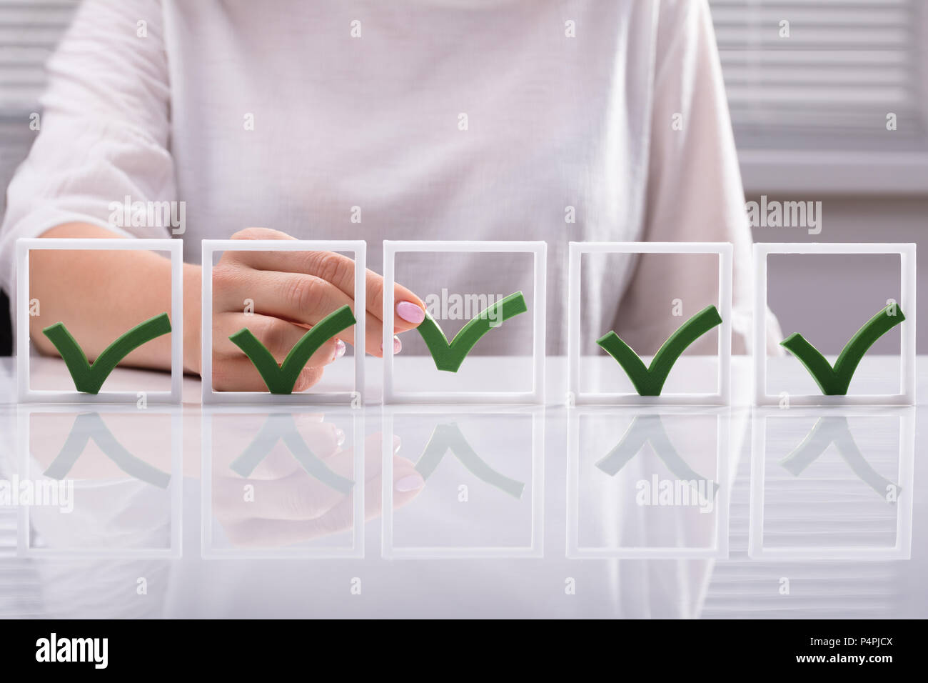 Close-up Of A Businesswoman's Hand Placing Green Check Mark Inside ...