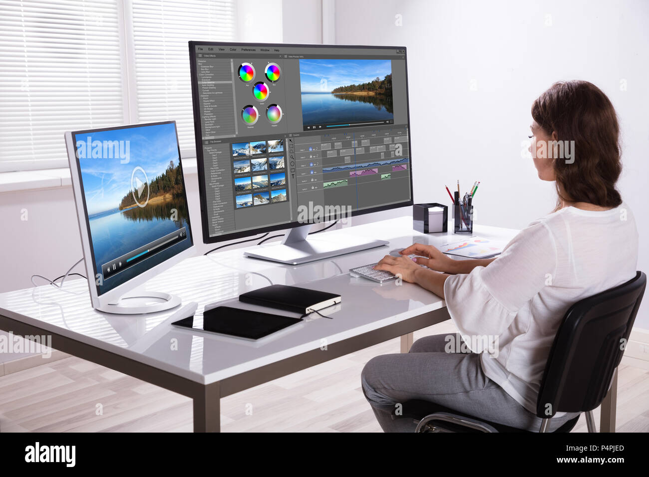 Young Female Editor Editing Video On Computer In Office Stock Photo - Alamy