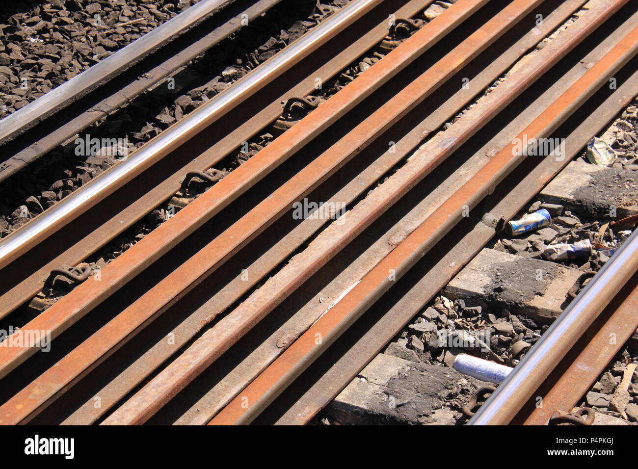 Various lengths of train track showing signs of weathering and rusting ...