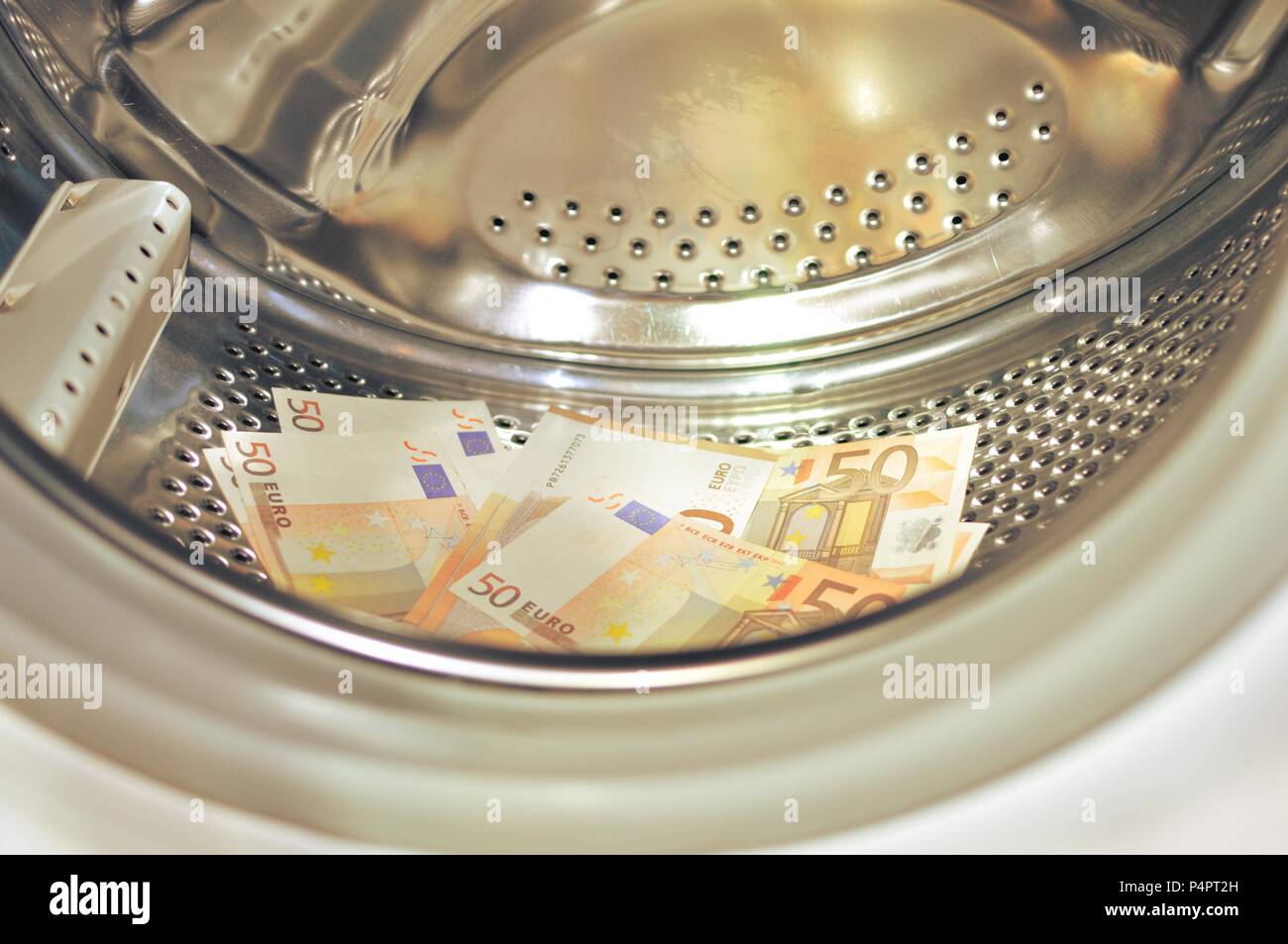 Concept symbol of money laundering in washing machine with the door ...