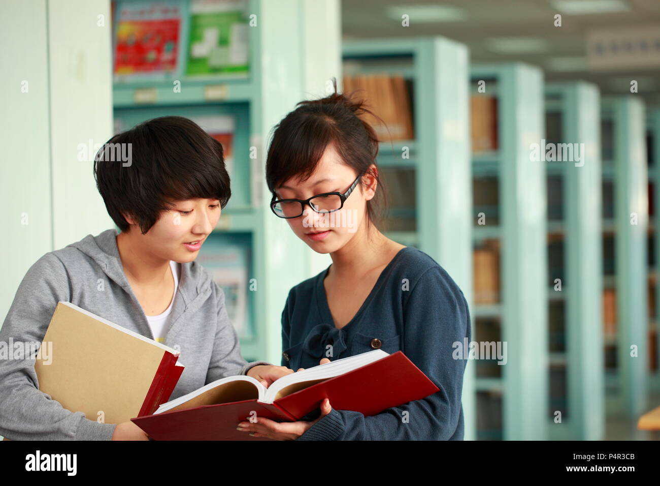 two female Chinese college students study in the library Stock Photo ...