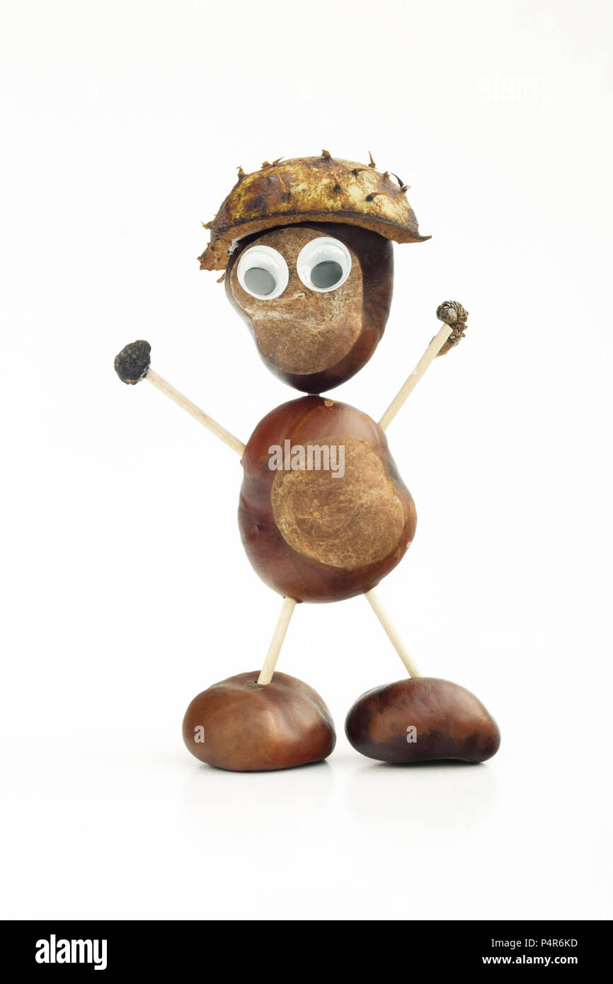 Funny human shape character or figurine made with chestnuts in white ...