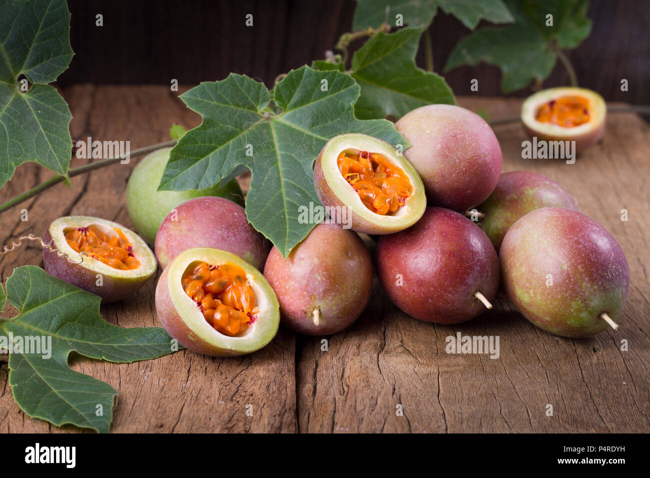 fruits of gulupa on vine wood table, Passiflora pinnatistipula Stock ...