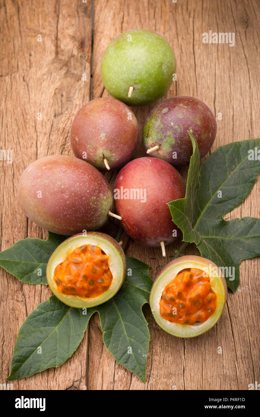 fruits of gulupa on vine wood table, Passiflora pinnatistipula Stock ...