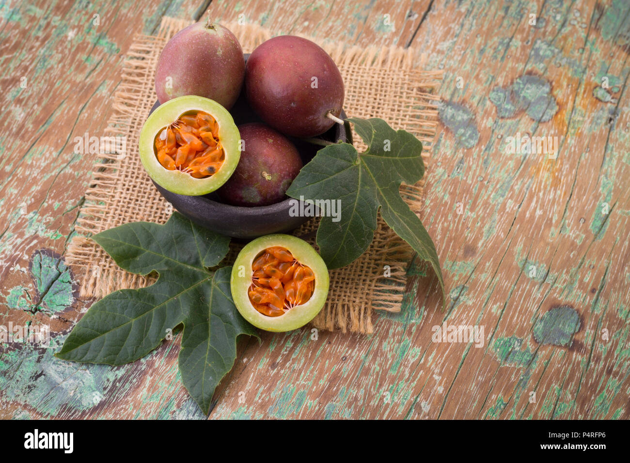 fruits of gulupa on vine wood table, Passiflora pinnatistipula Stock ...