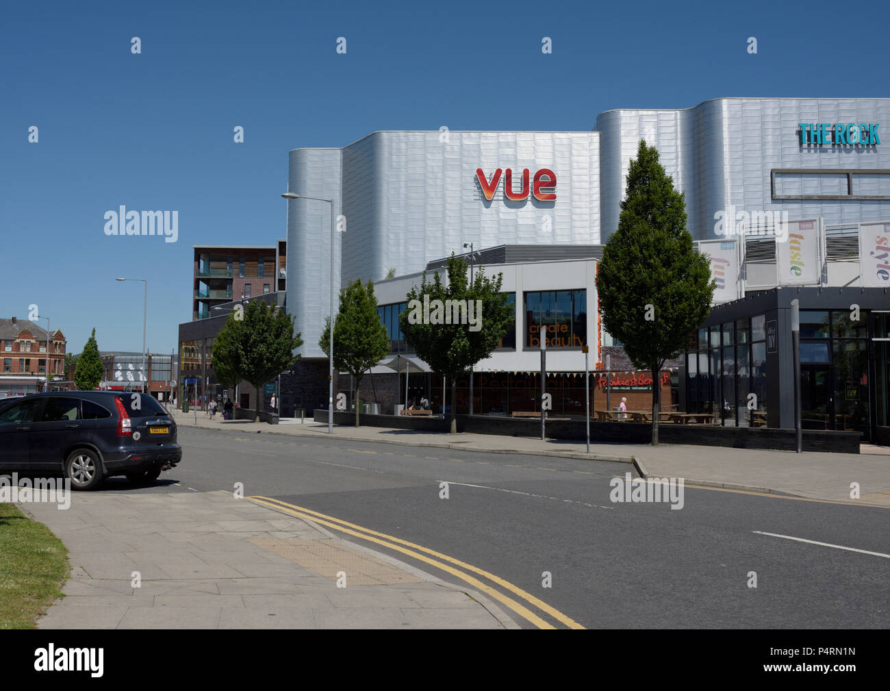 Modern buildings with aluminium cladding, vue cinema, trees pavement ...