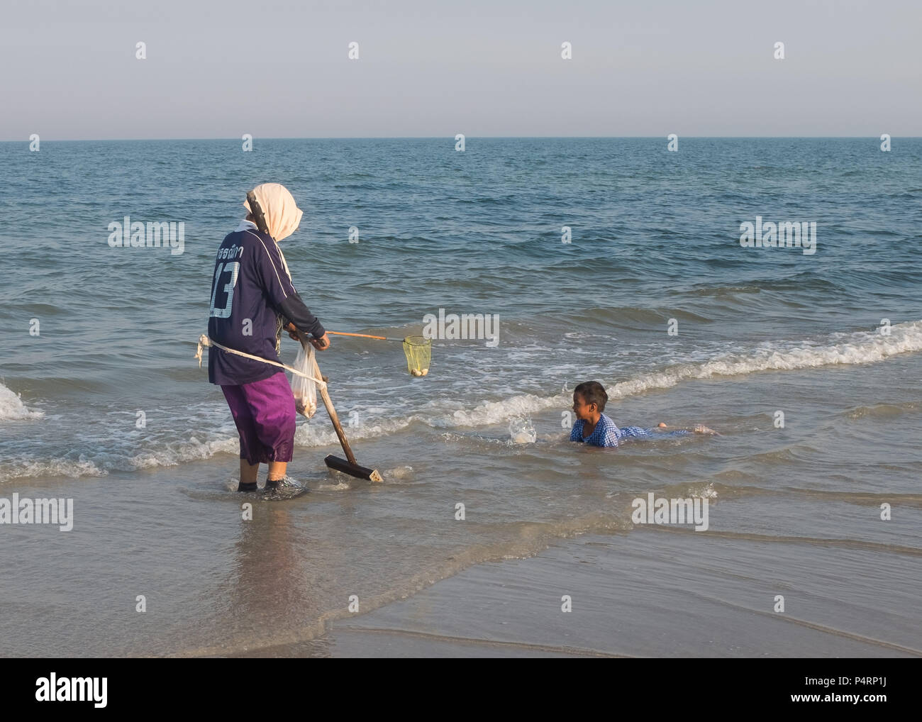 Woman collecting shells hi-res stock photography and images - Alamy