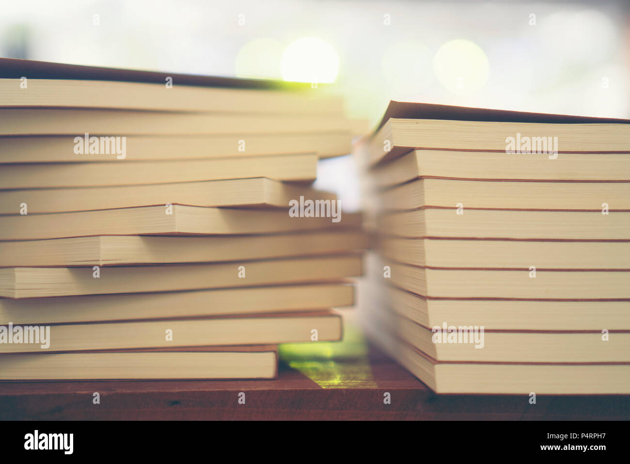 Book stack in the library room and blurred bookshelf for business and ...