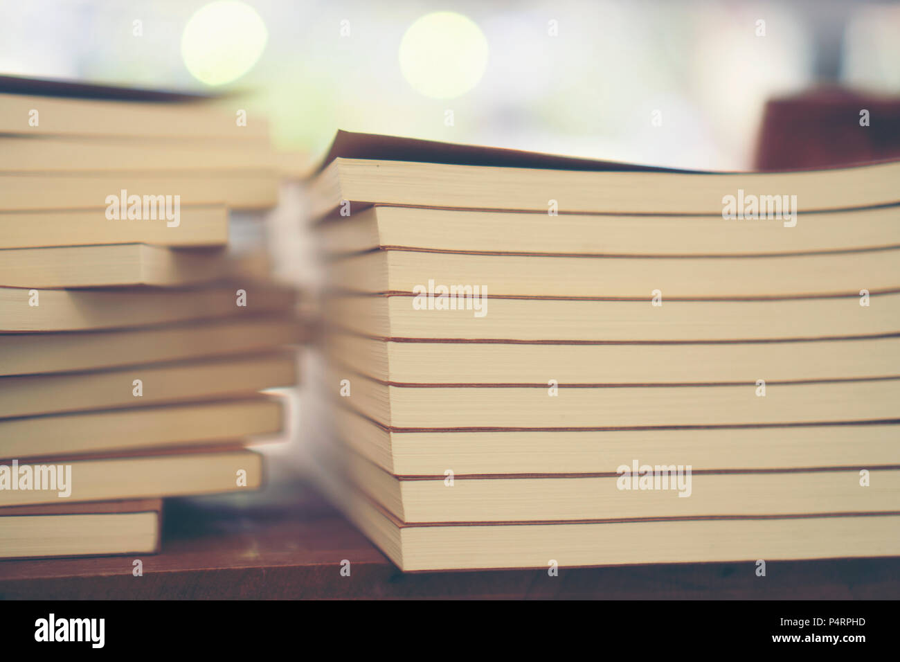 Book stack in the library room and blurred bookshelf for business and ...